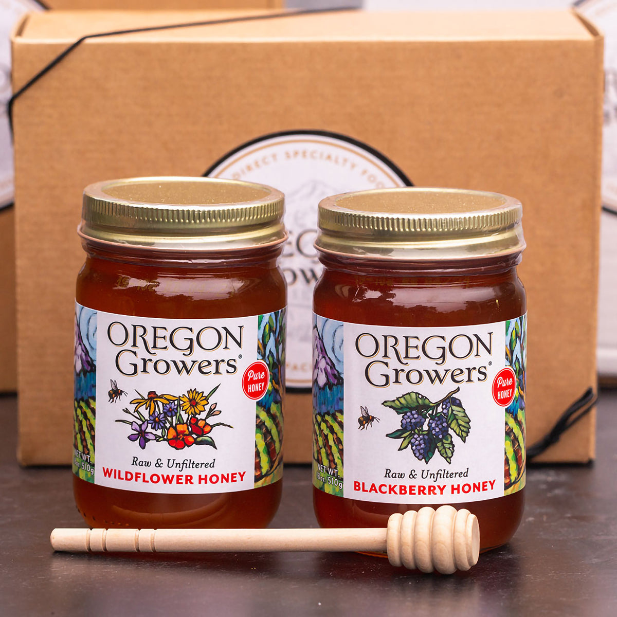 Jars of Blackberry and Wildflower Honey with wooden honey dipper in box